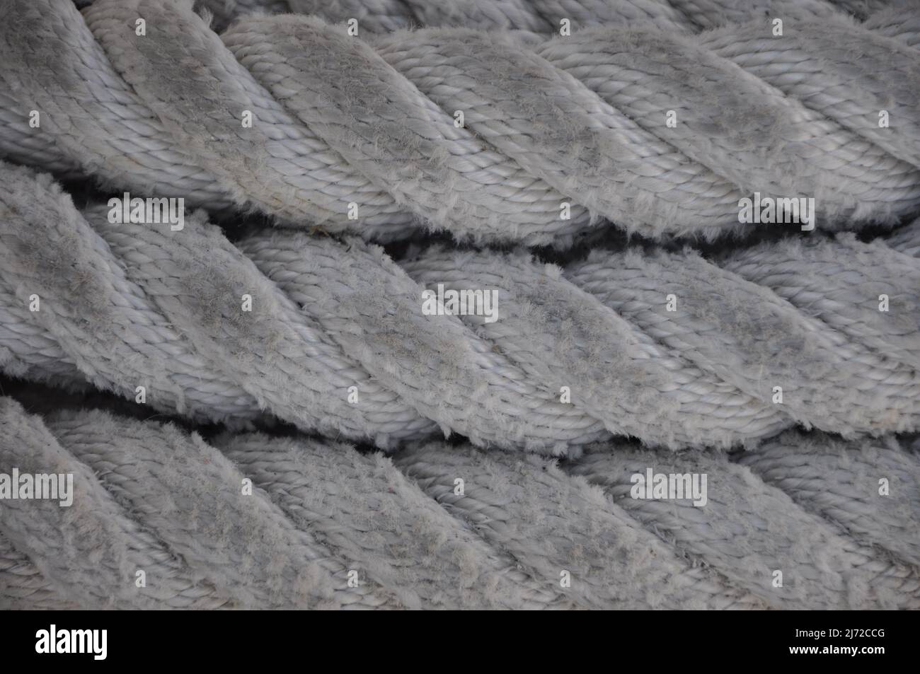 White nautical rope on travel boat. Nautical mooring rope. Close-up of ...