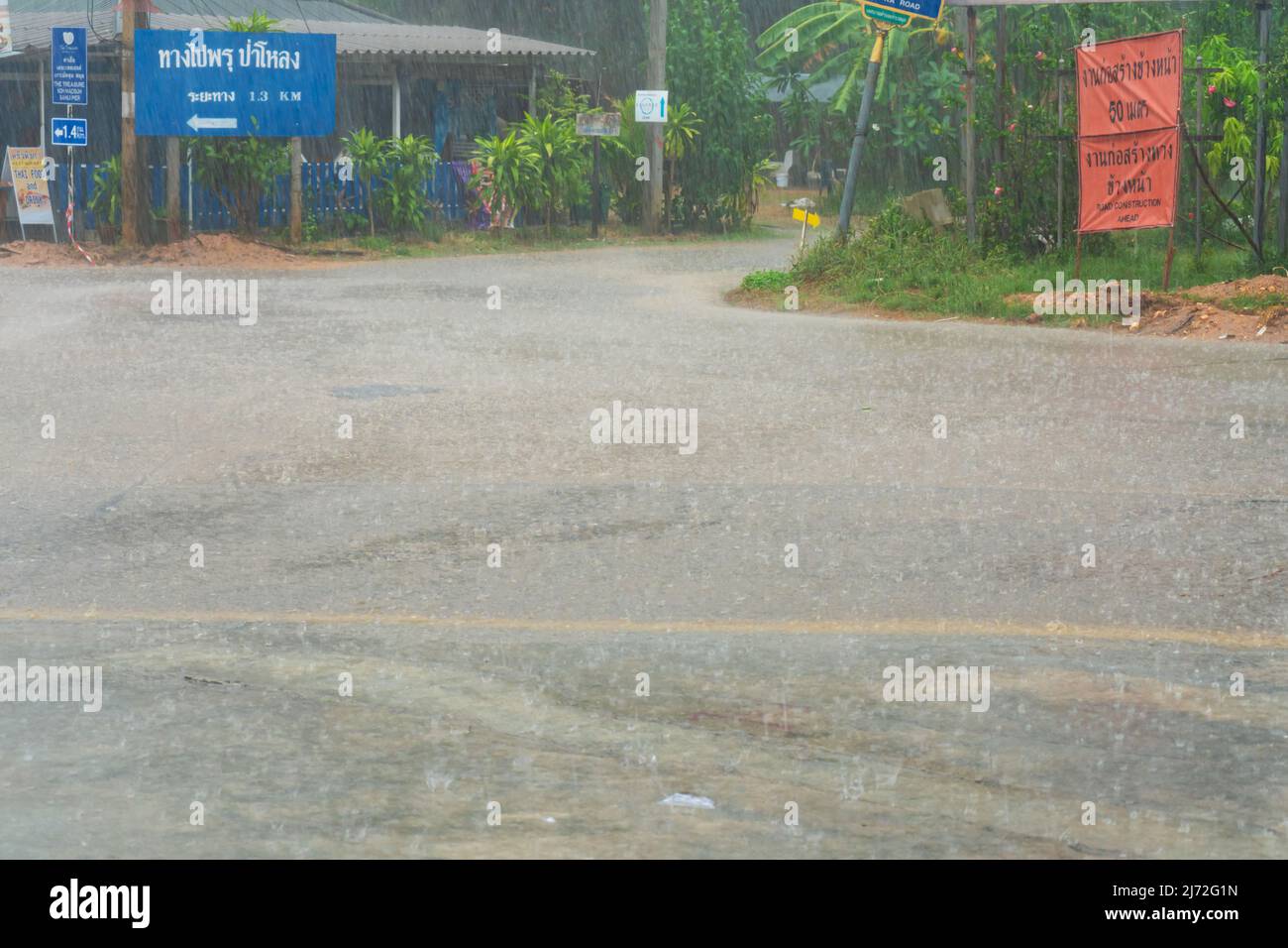 Heavy tropical rain on an island in Thailand. The road is under water ...