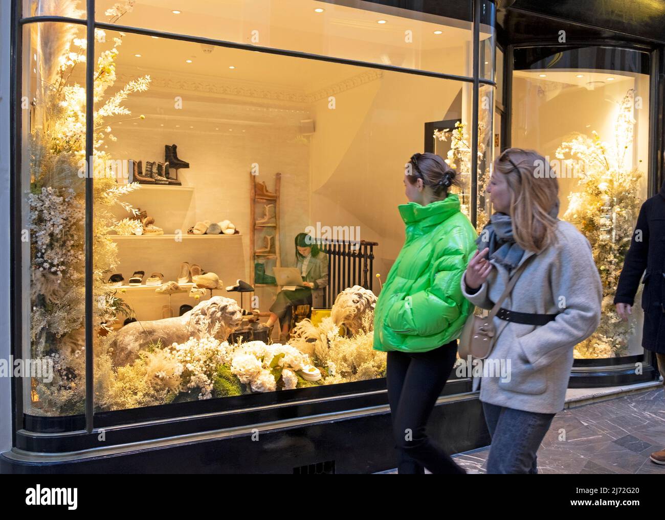 Young women tourists looking in shop window at Burlington Arcade ...