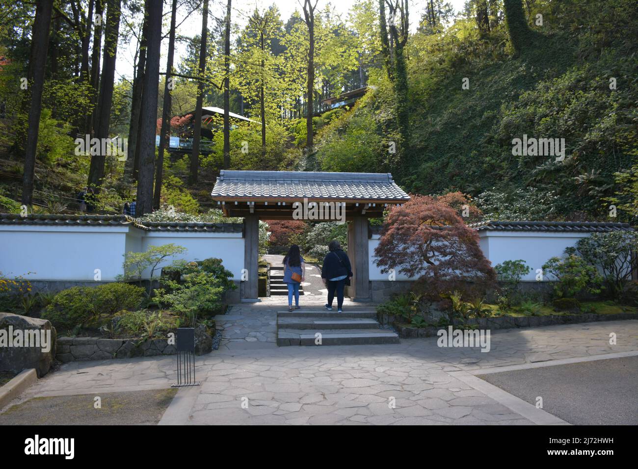 Two visitors enter via the Antique Gate, a traditional style entrance ...
