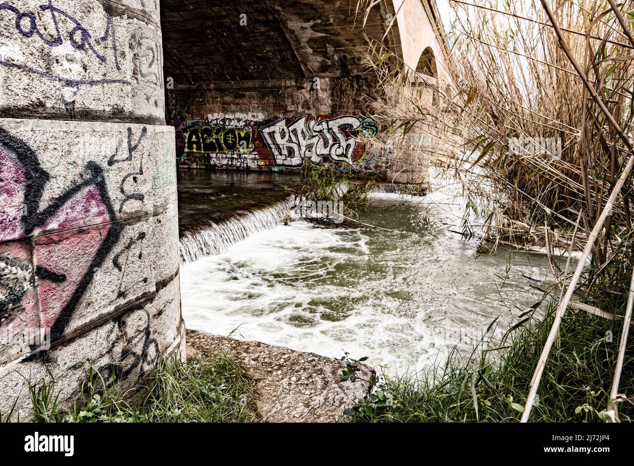 Natural landscape of Algar river in flood rushing under the road bridge ...