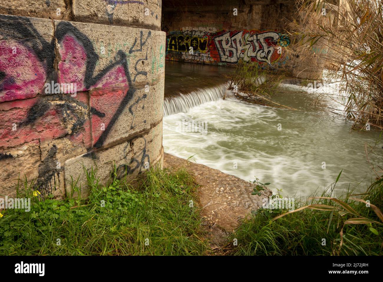 Natural landscape of Algar river in flood rushing under the road bridge ...