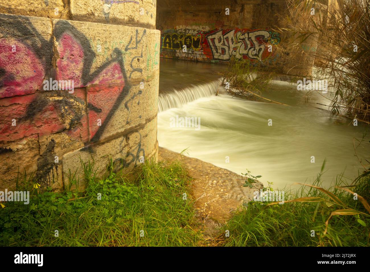 Natural landscape of Algar river in flood rushing under the road bridge ...
