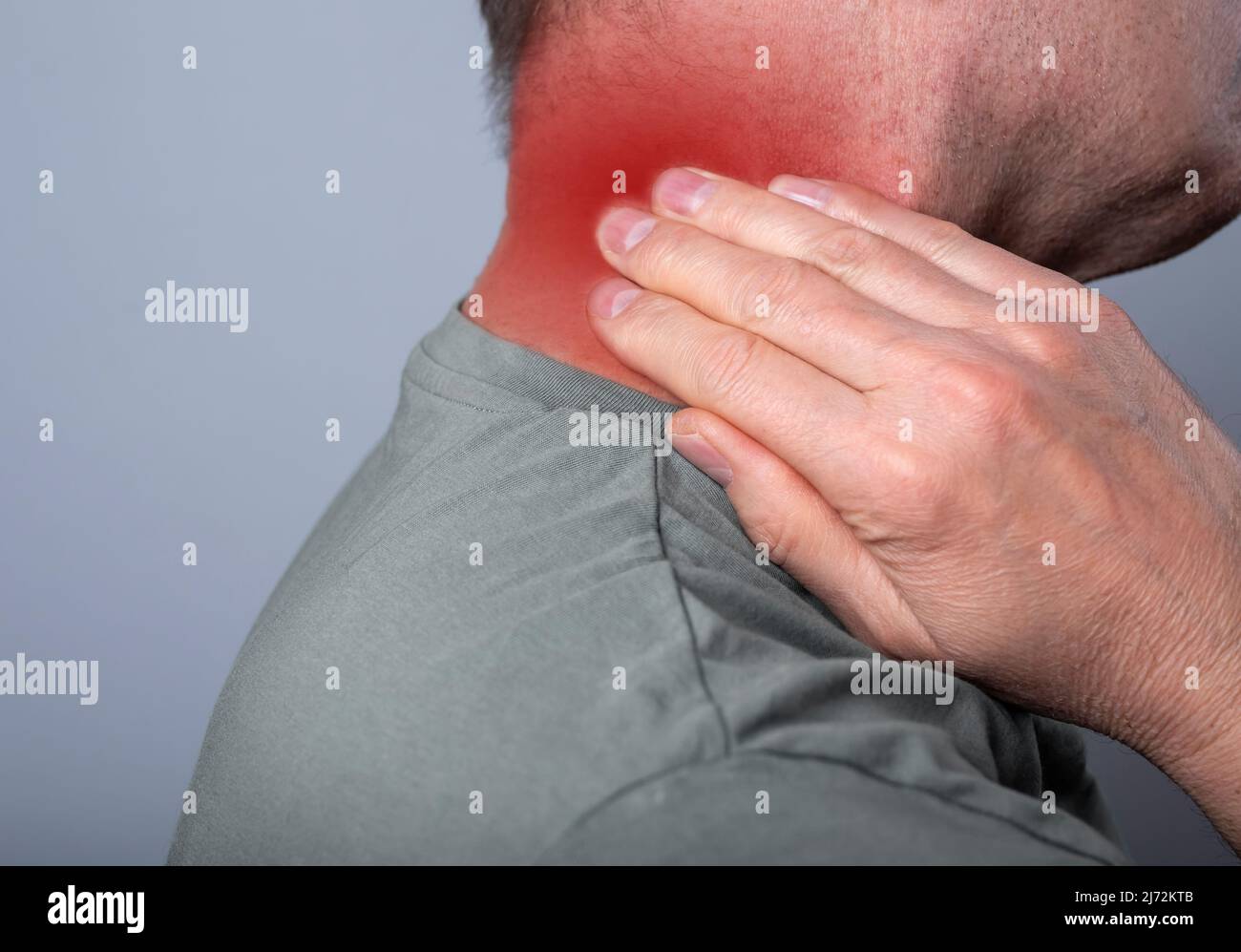 Neck strain closeup. Male hand touching hurting injury, pain with red ...