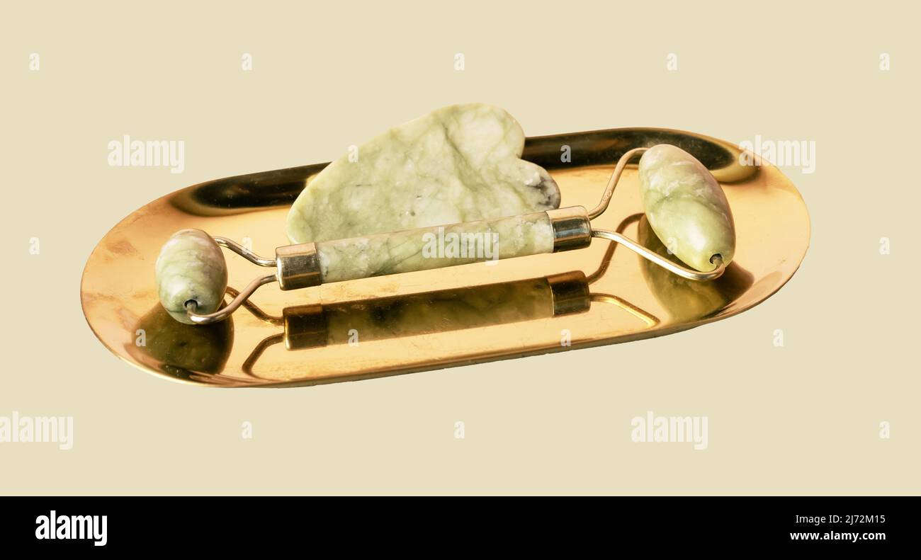 Gua Sha massage stone instruments. Scraper and roller Stock Photo - Alamy