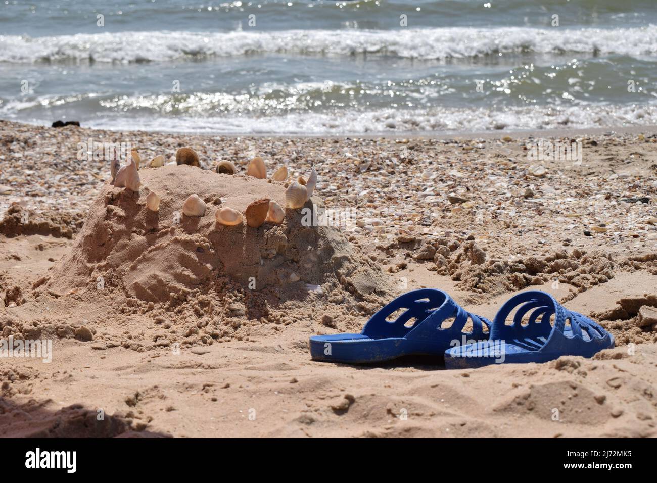 Beautiful beach. Blue Beach sandals on the sandy coast. Summer holiday ...