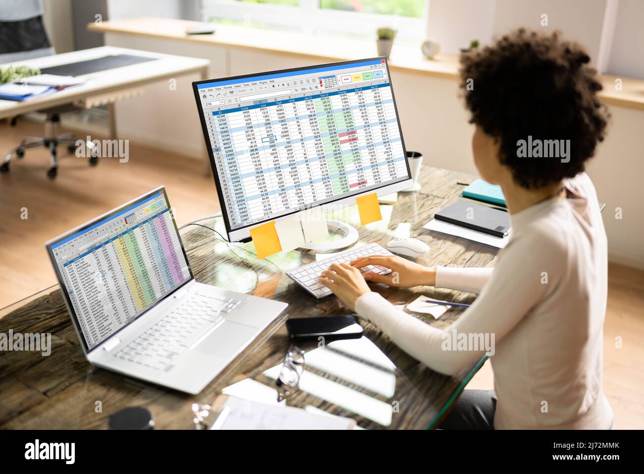 African American Spreadsheet Data Analyst Using Computer Software Stock ...