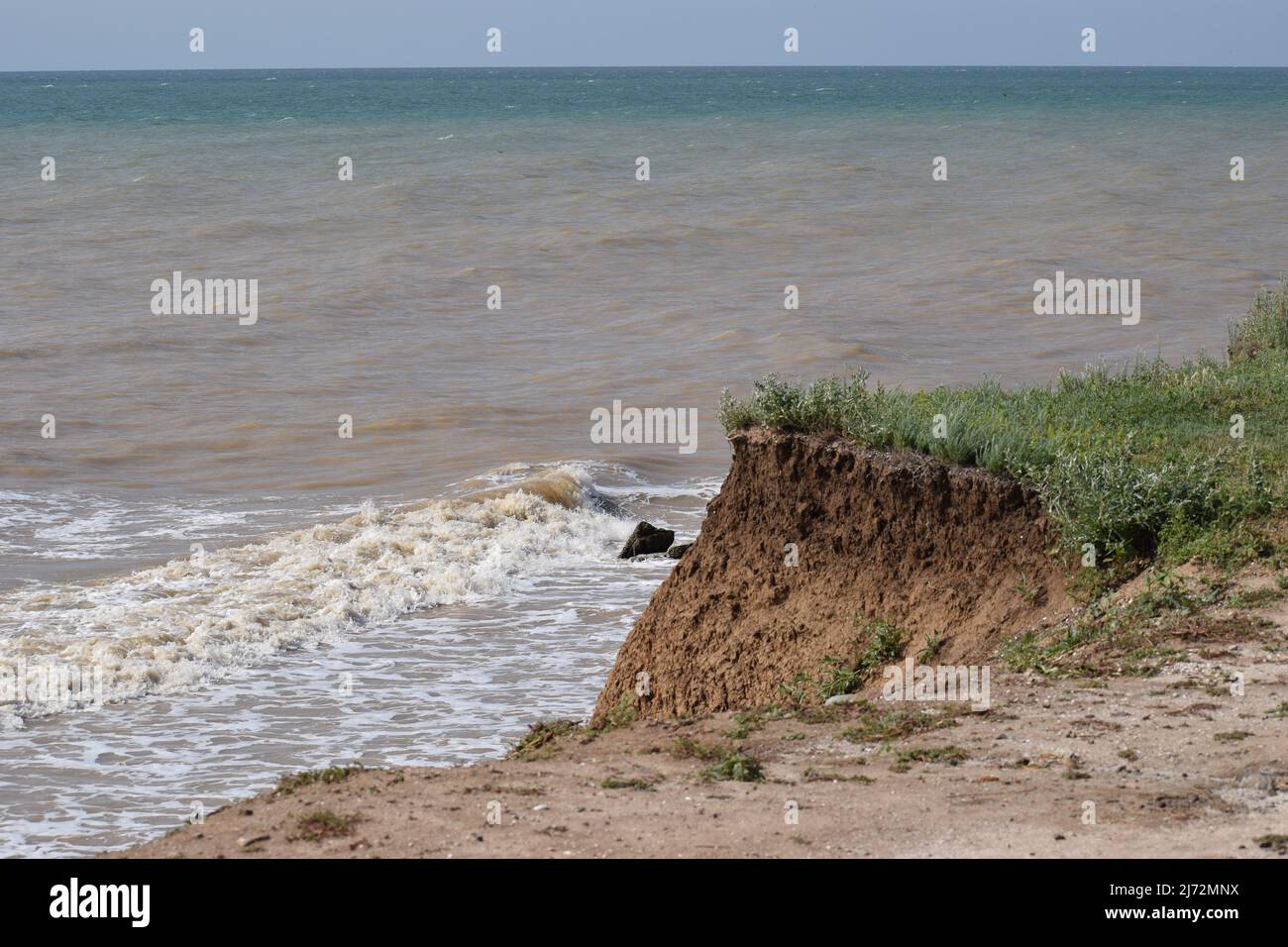 Sea cliffs of boulder clay in front of beaches. Clay Cliffs and Beach with Blue Sky and Water ...