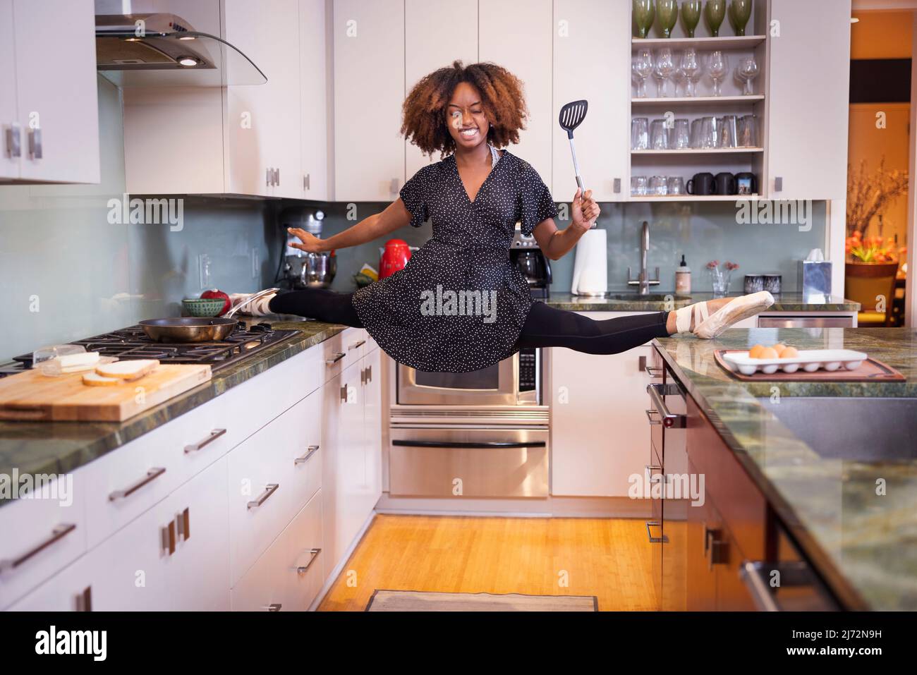 A ballet dancer taking her dancing home with her, cooking breakfast ...