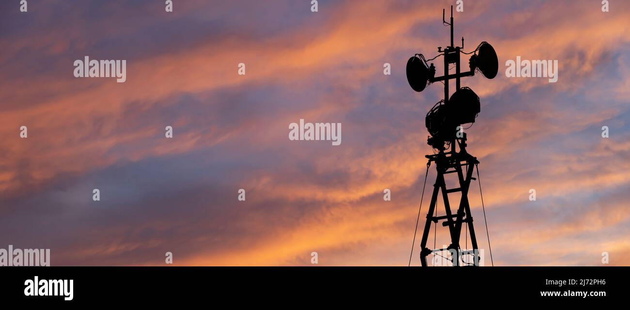 Contour small military radar station on the background of the sunset ...