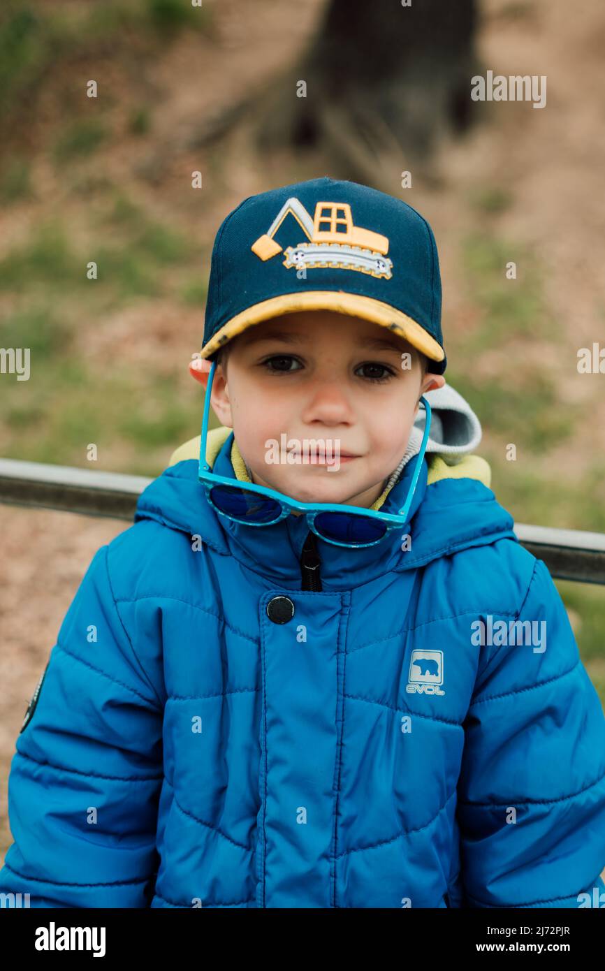 Portrait of a little boy in sunglasses and a cap Stock Photo - Alamy