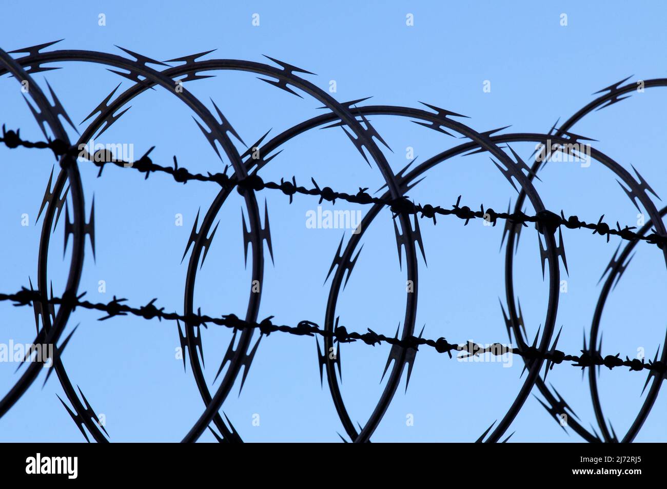 Razor wire and barbed wire Stock Photo - Alamy