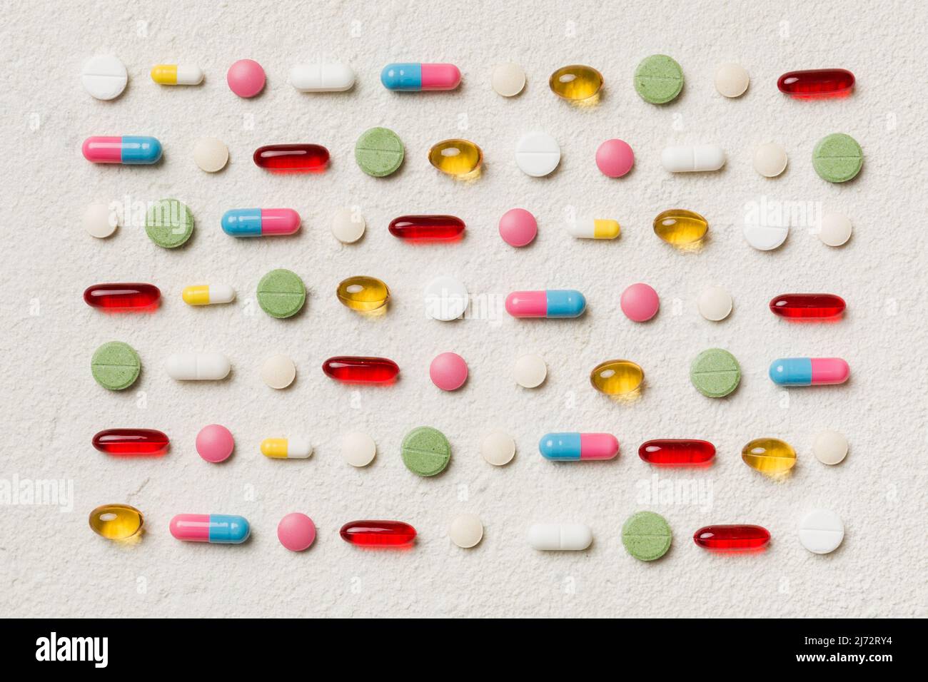 Many different pills and space for text on colorful background, top ...