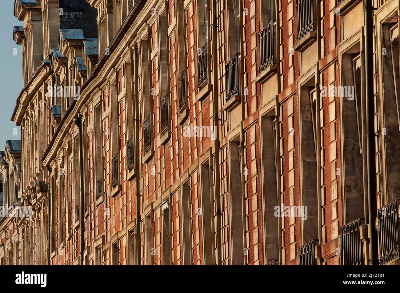 Building façades opposite square Louis XIII under the late afternoon ...