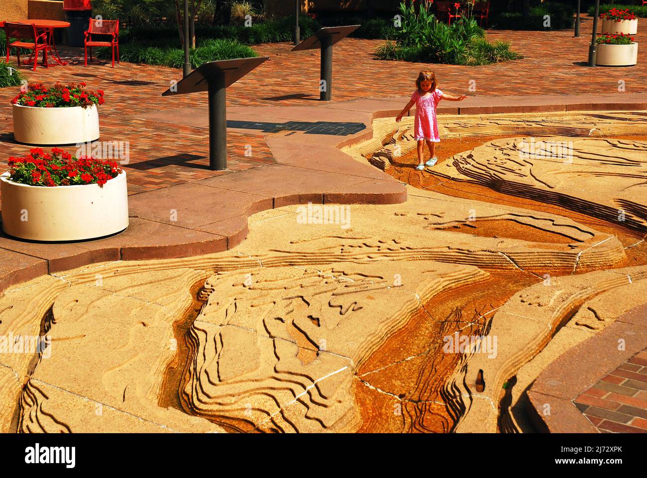 A young girl walks through a scale model of the Mississippi River at ...