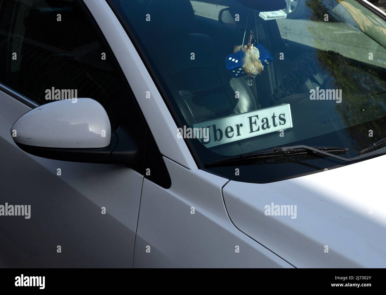An Uber Eats car and driver making a delivery in San Francisco ...
