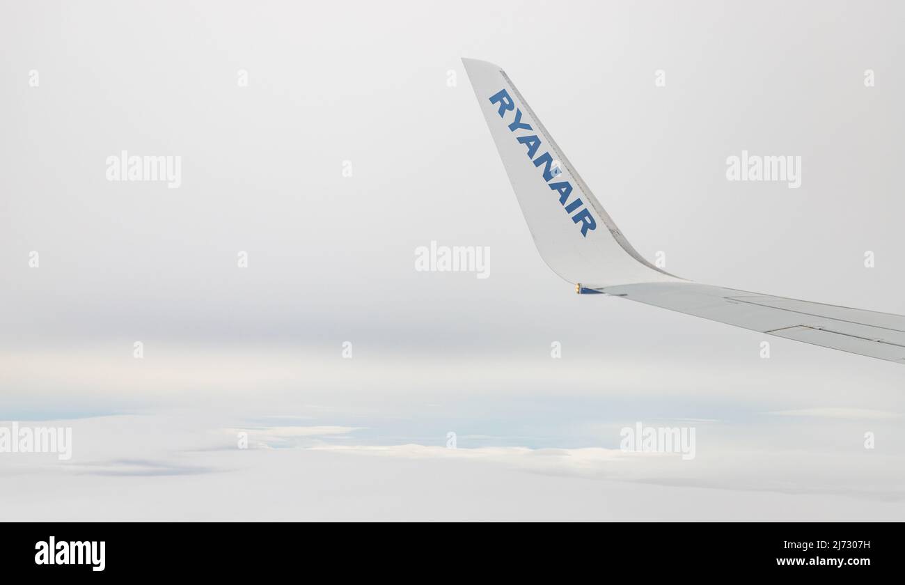 A picture of a Ryanair wing flying between the clouds Stock Photo - Alamy