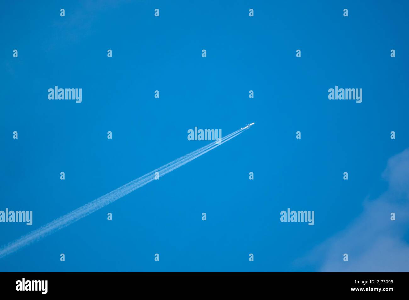 diagonal lower left to upper right high altitude contrails from a twin ...