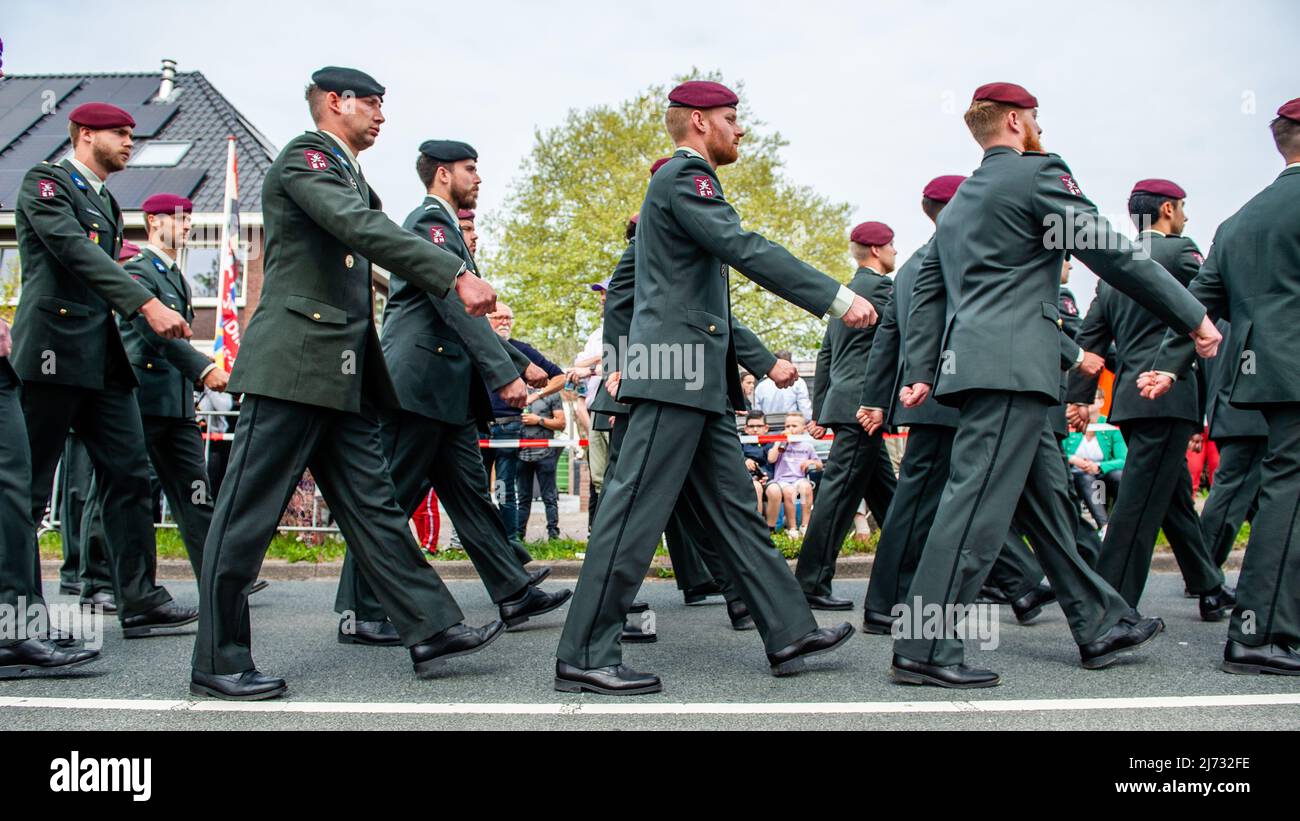 Military officers are seen marching during the Liberation Day parade ...