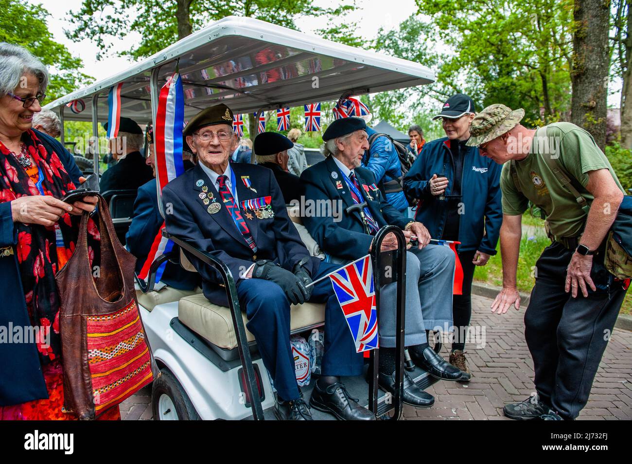 People are seen chatting with the WWII British veterans before the ...