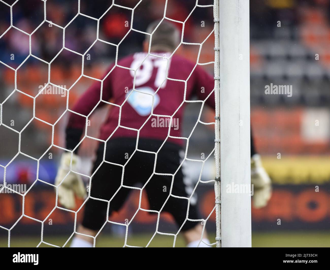 Detail of goal's post with net and football goalkeeper in the ...