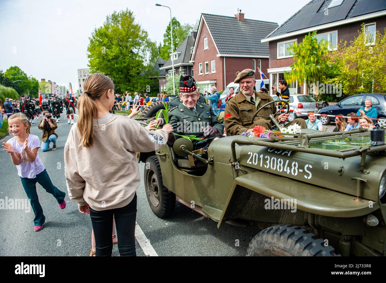 Girls are seen giving flowers to the veterans during the Liberation Day ...
