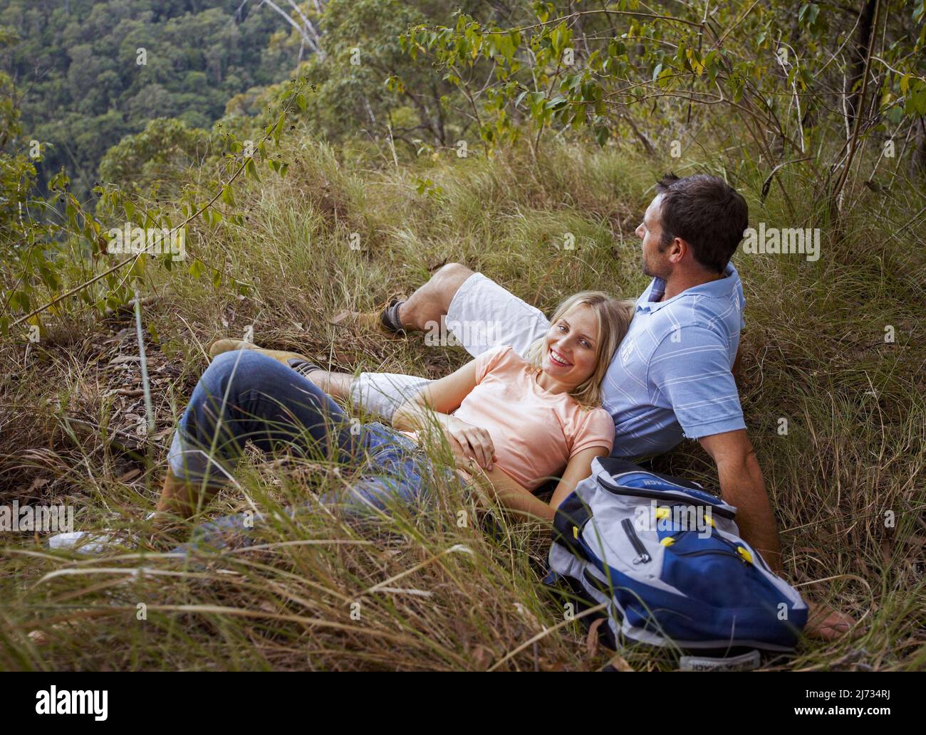 Couple with backpack resting in bushland in Australian Outback Stock ...