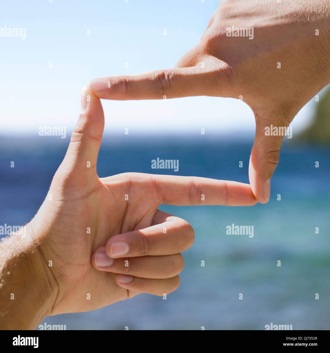 Young man holding up hands using this fingers to frame up image Stock ...