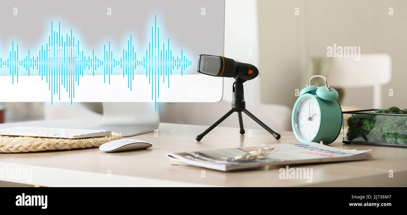 Professional microphone with computer on table in room Stock Photo - Alamy