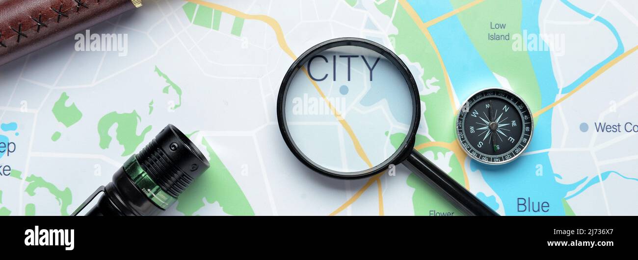 Magnifier, compass and flashlight on map. Banner for design Stock Photo ...