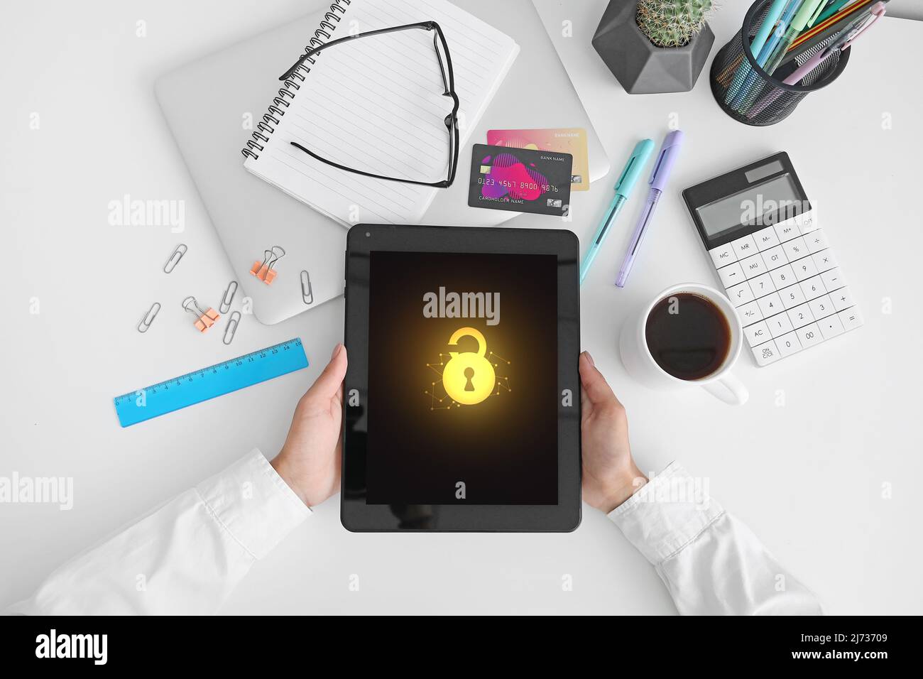 Office worker using tablet computer with locked screen at table, top ...