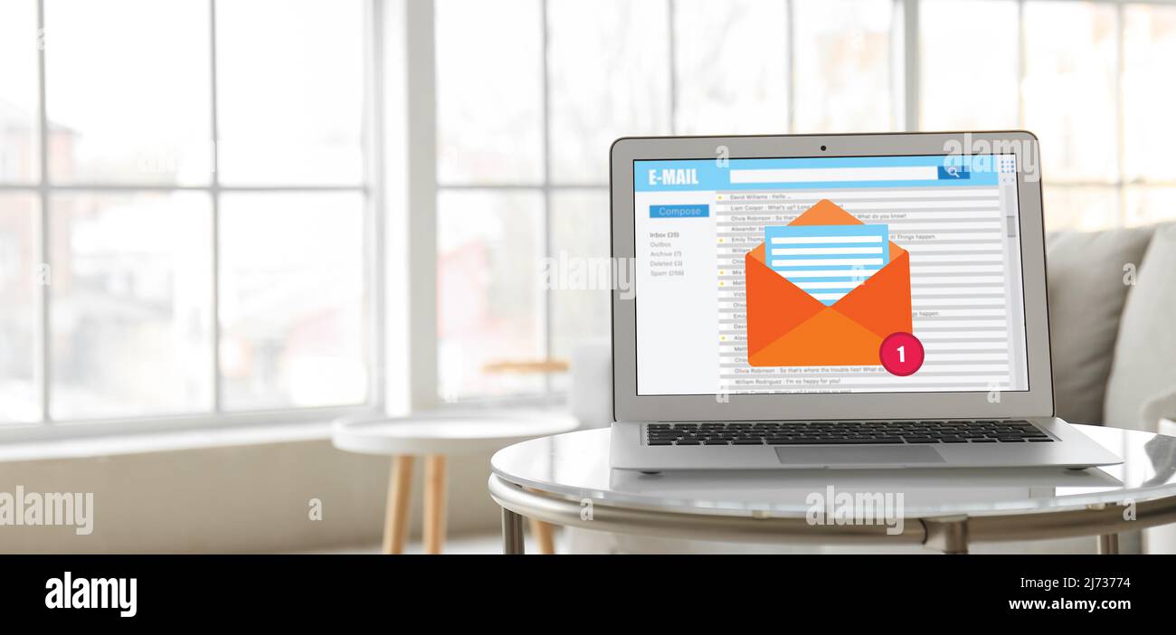Laptop with symbol of new unread message on screen in room Stock Photo ...