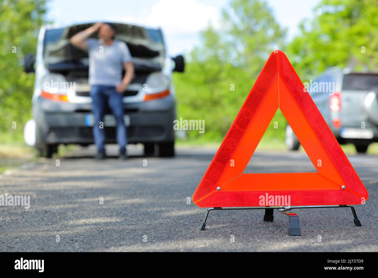 Emergency stop sign and stressed man near broken car outdoors Stock ...