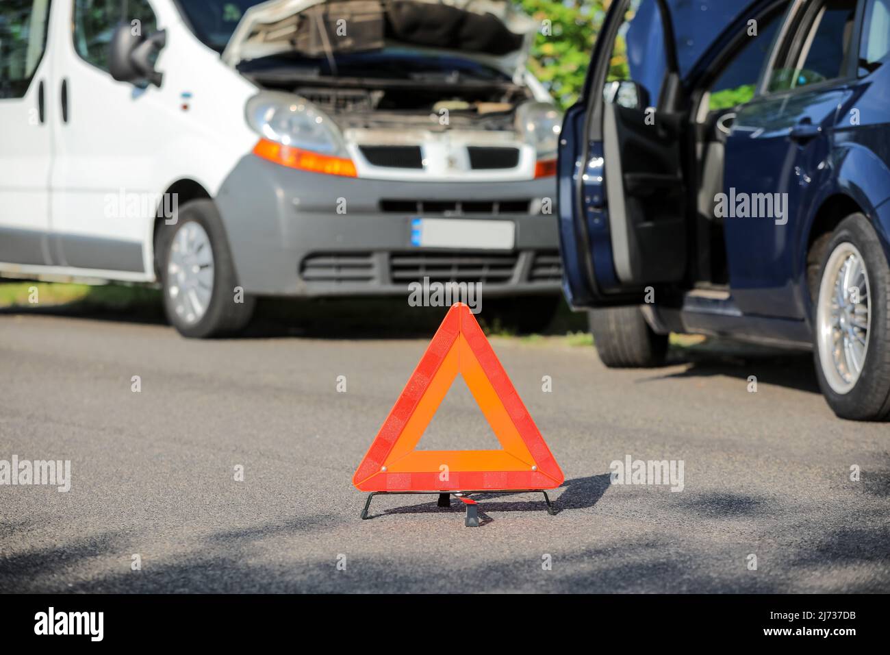 Emergency triangle stop sign near broken cars on road Stock Photo - Alamy