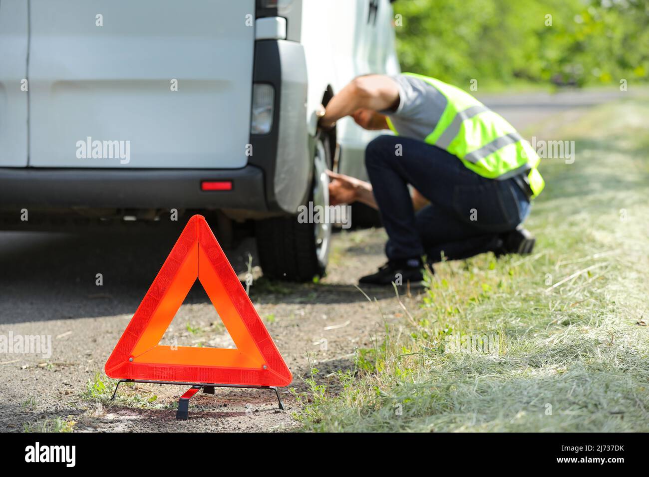 Emergency stop sign and man near broken car outdoors Stock Photo - Alamy