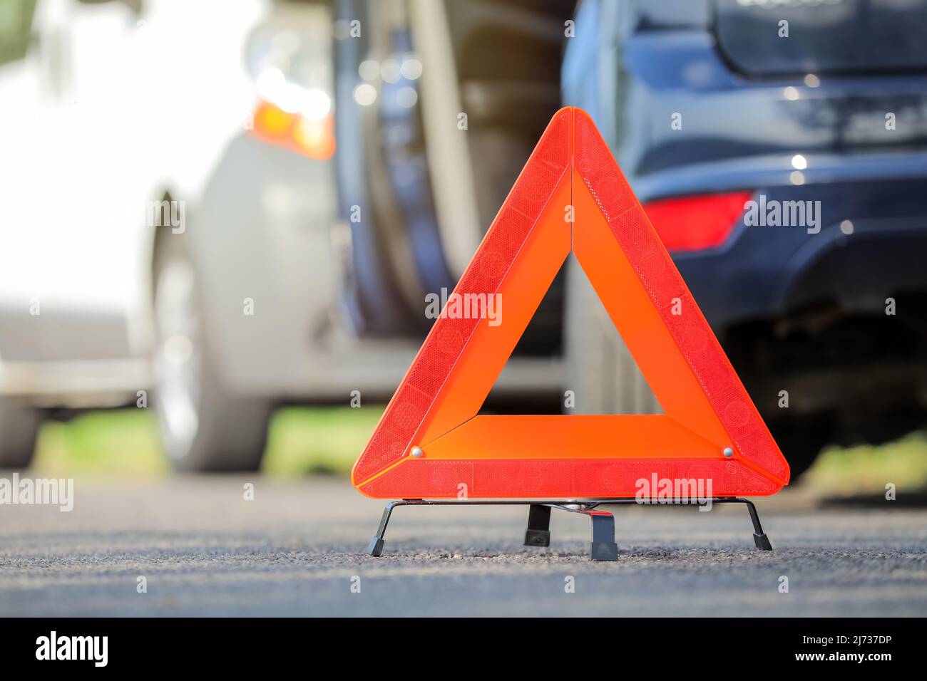 Emergency triangle stop sign and broken cars on background Stock Photo ...