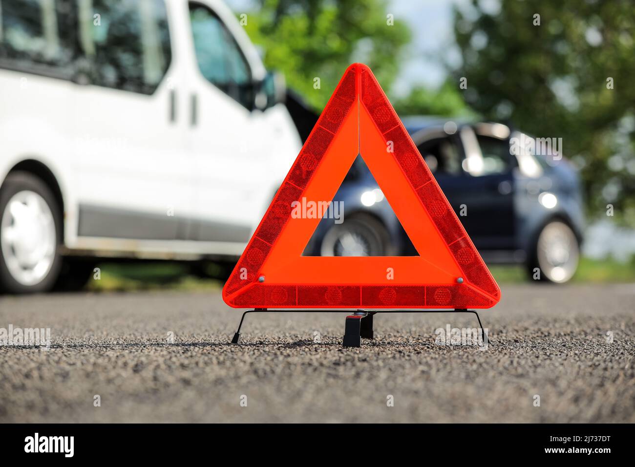 Emergency triangle stop sign near broken cars on road Stock Photo - Alamy