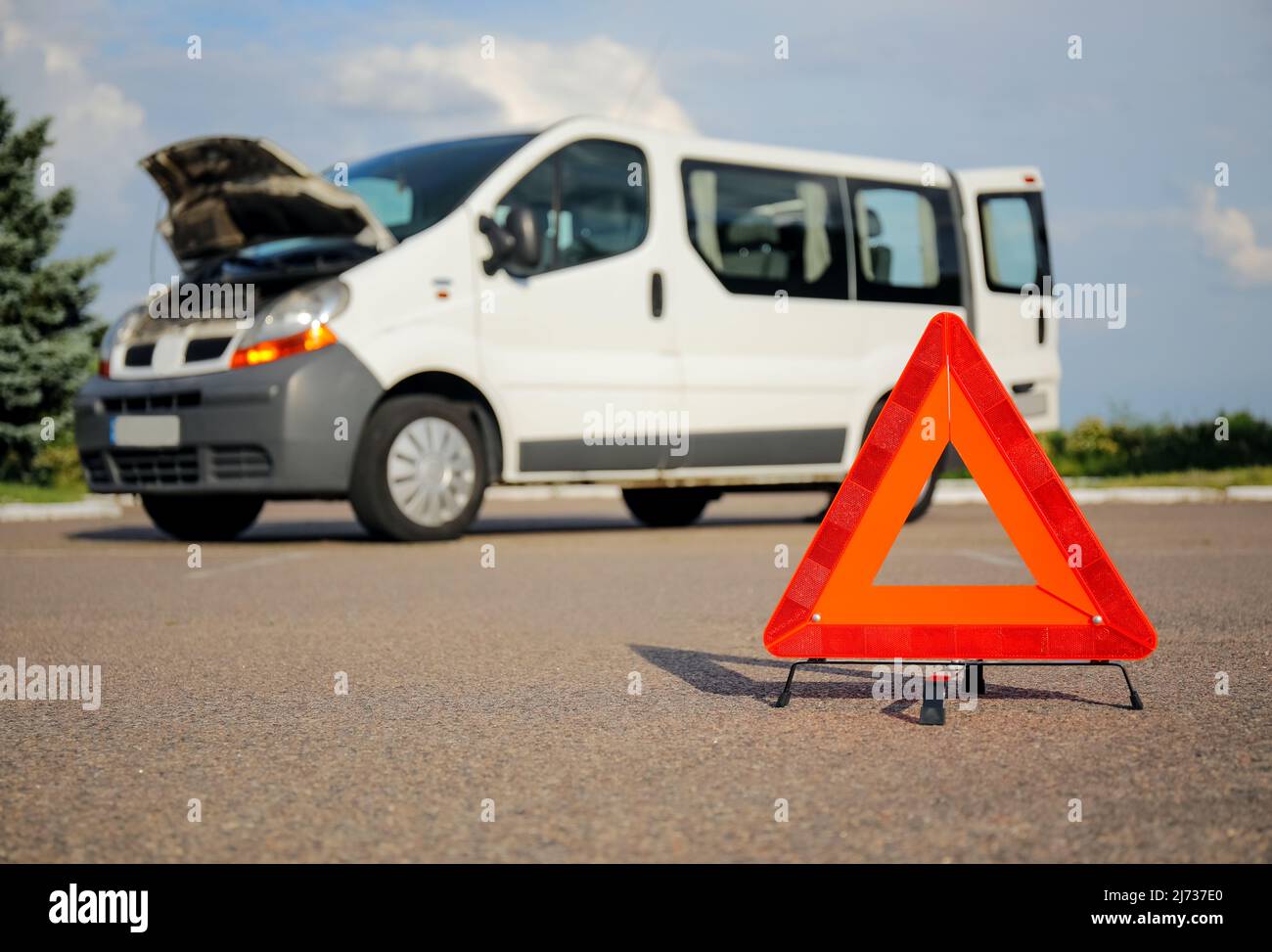 Emergency triangle stop sign and broken car on road Stock Photo - Alamy