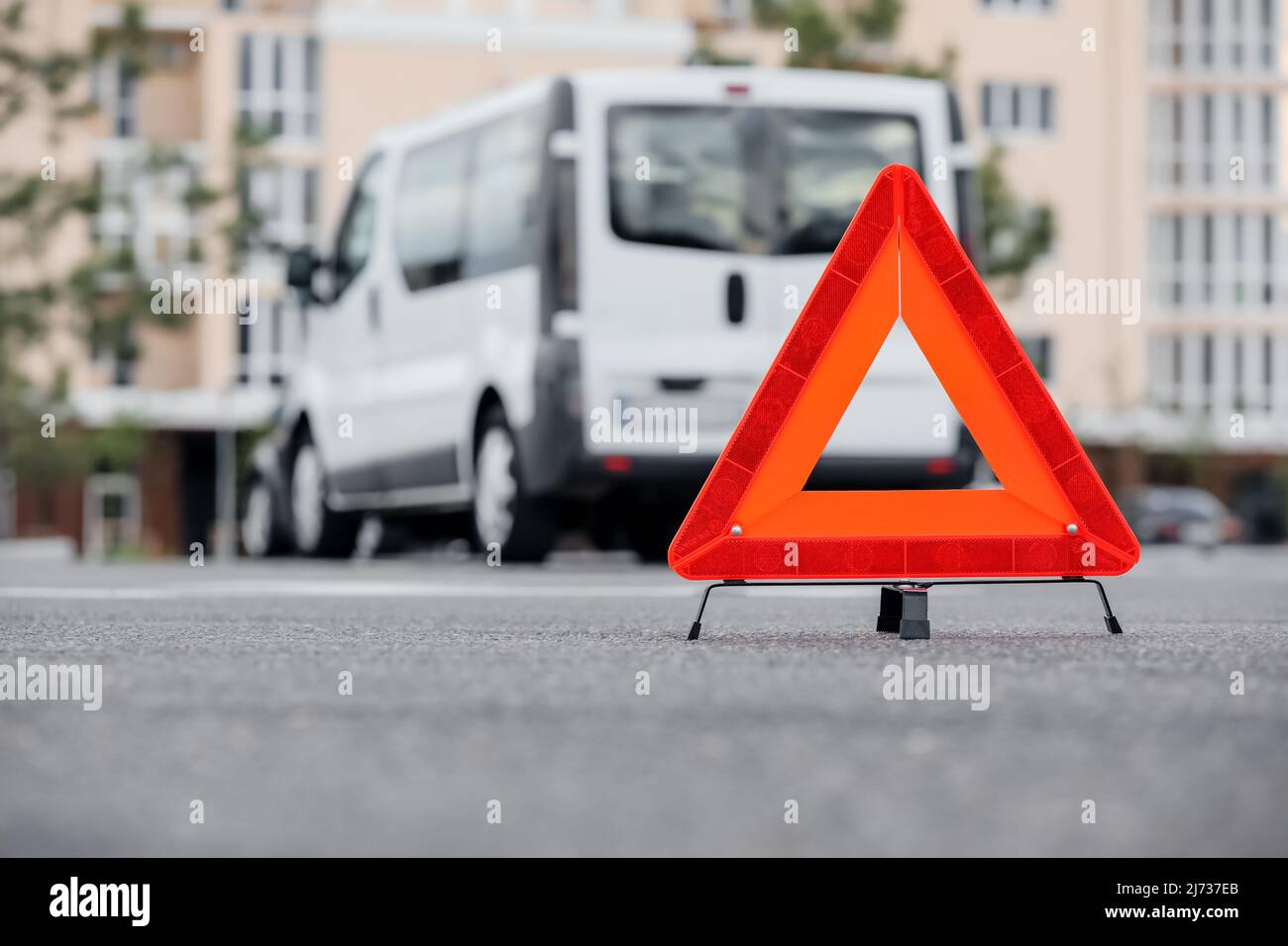 Red emergency triangle stop sign on road Stock Photo - Alamy
