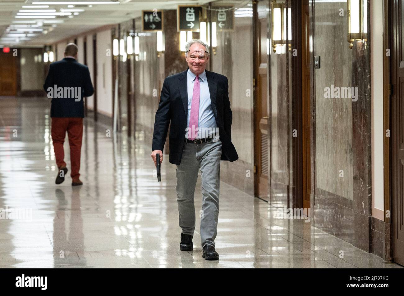 U.S. Senator Tim Kaine (D-VA) walking down a hallway at the Dirksen ...