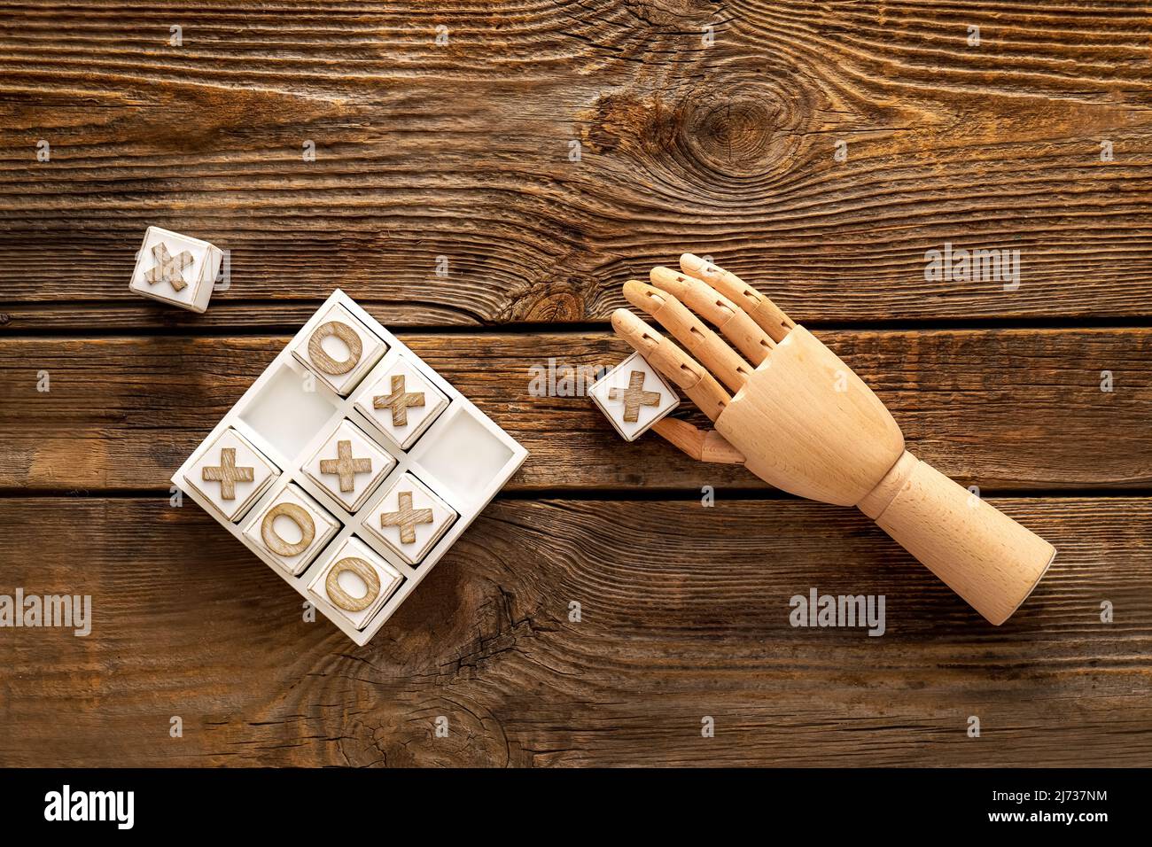 Game of Tic-Tac-Toe and decorative hand on wooden background Stock ...