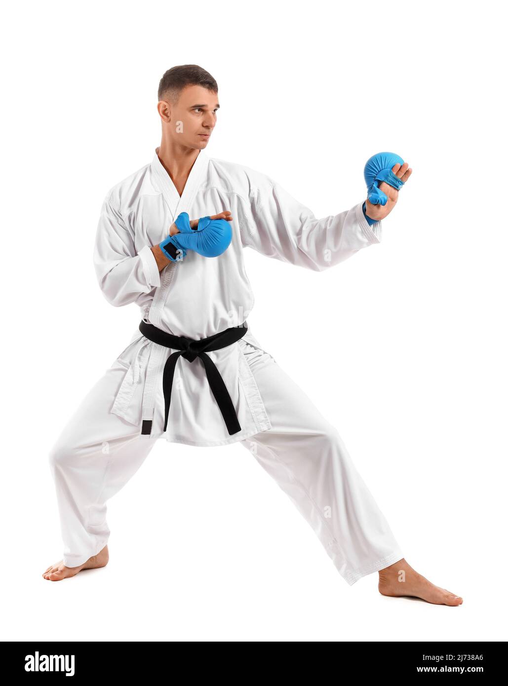 Man with black belt practicing karate on white background Stock Photo ...