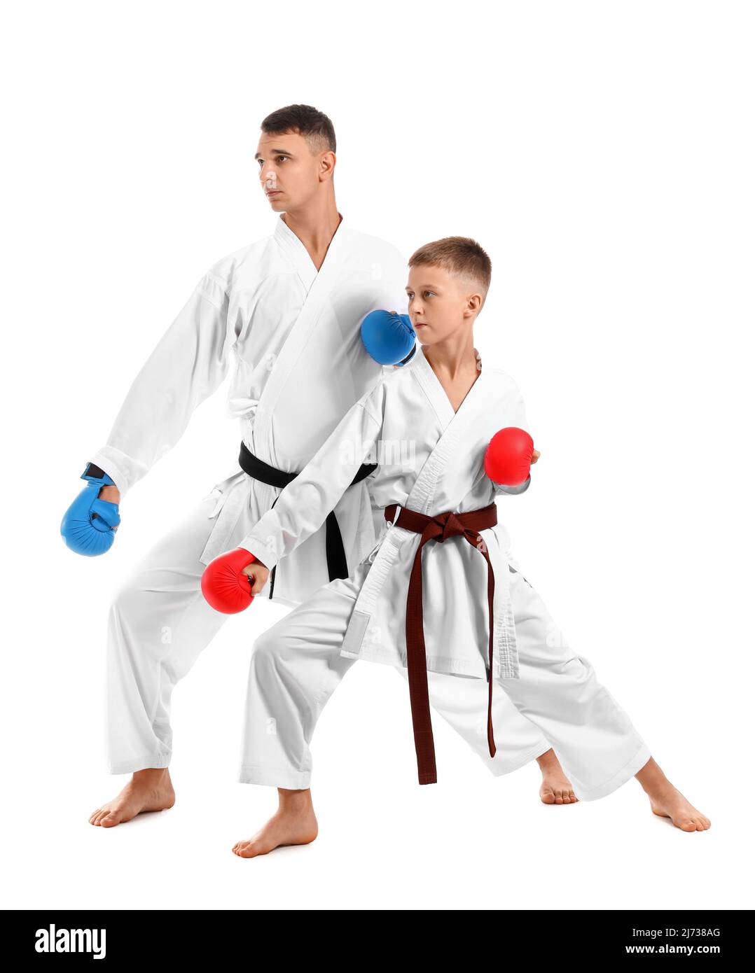 Boy practicing karate with instructor on white background Stock Photo ...