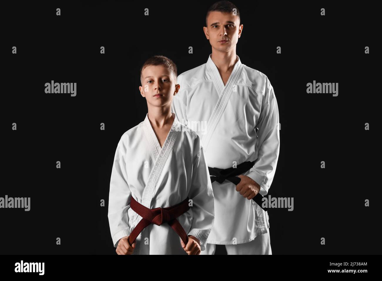 Boy with karate instructor on dark background Stock Photo - Alamy