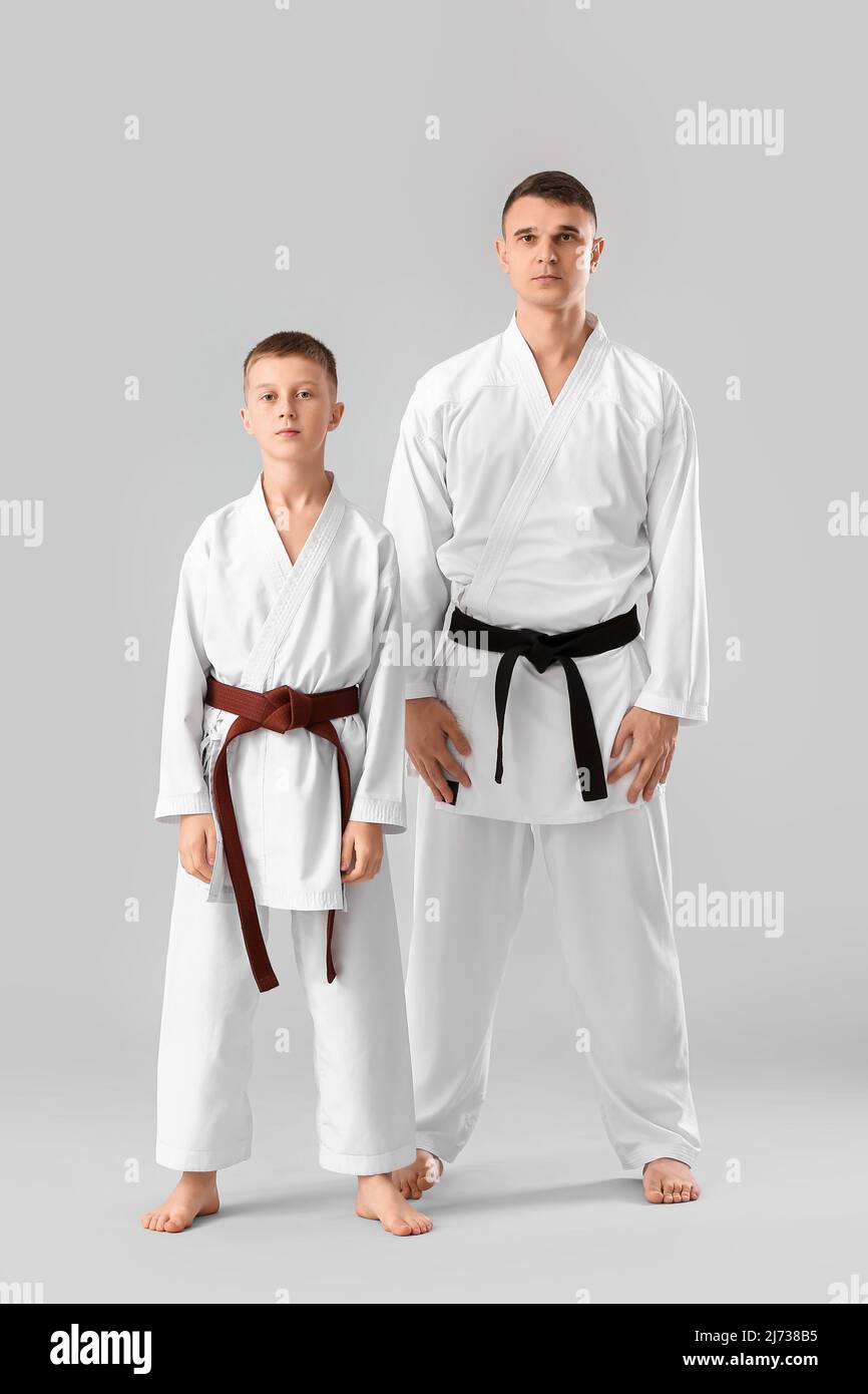Boy with karate instructor on light background Stock Photo - Alamy