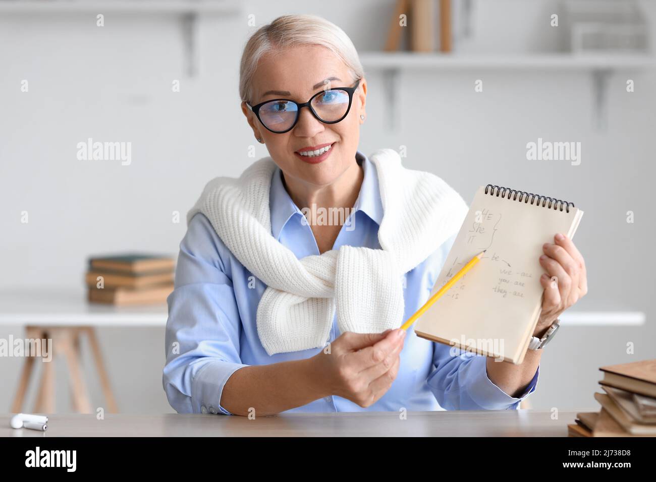 Female tutor giving lesson at home Stock Photo - Alamy