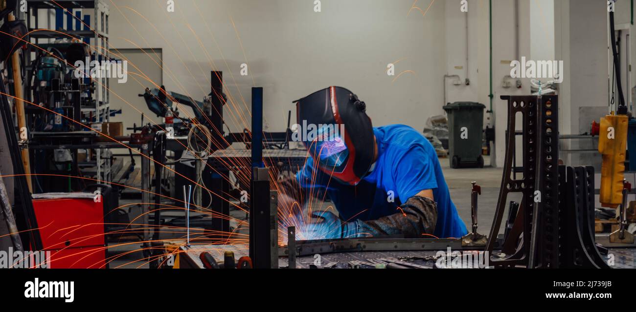Professional Heavy Industry Welder Working Inside factory, Wears Helmet ...
