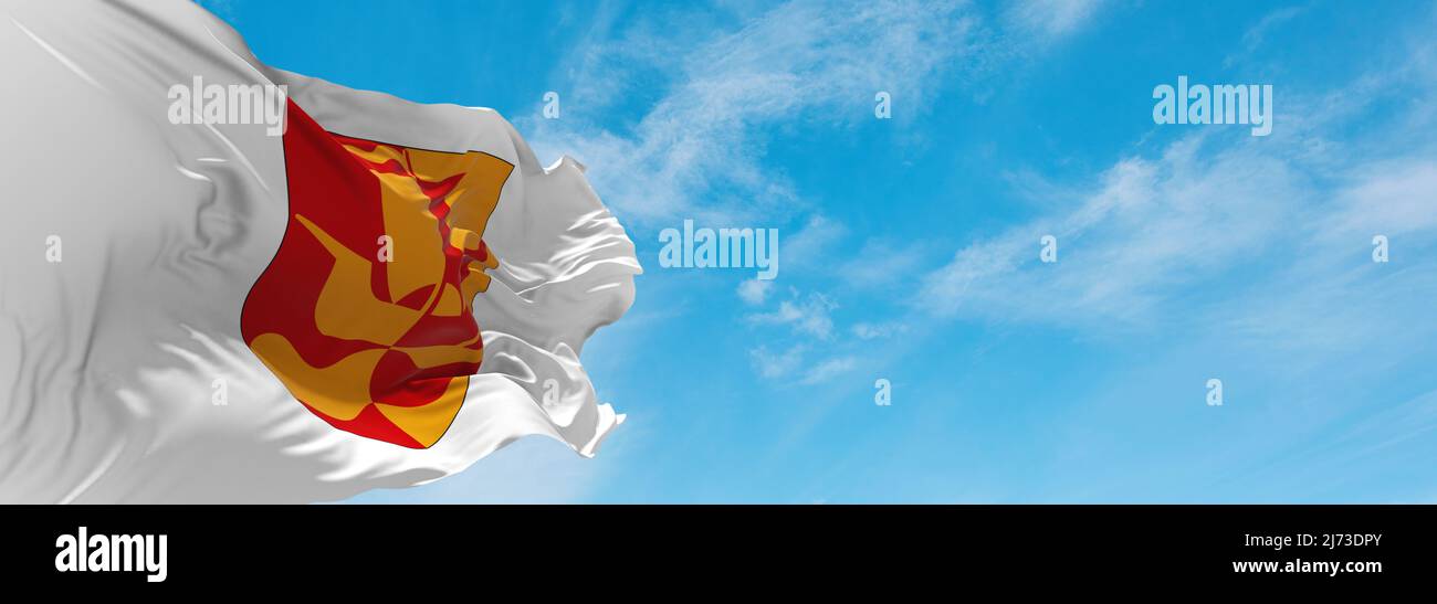 official flag of Guldborgsund Kommune , Denmark at cloudy sky ...