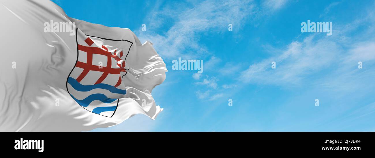 official flag of Haderslev Kommune , Denmark at cloudy sky background ...