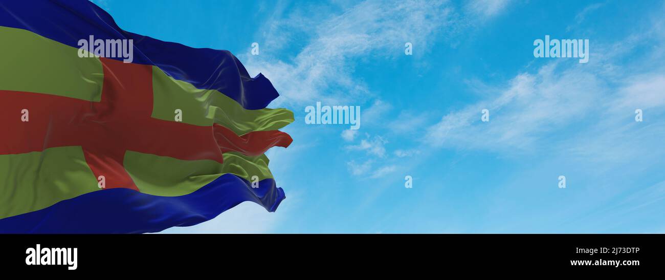 official flag of Jutland , Denmark at cloudy sky background on sunset ...
